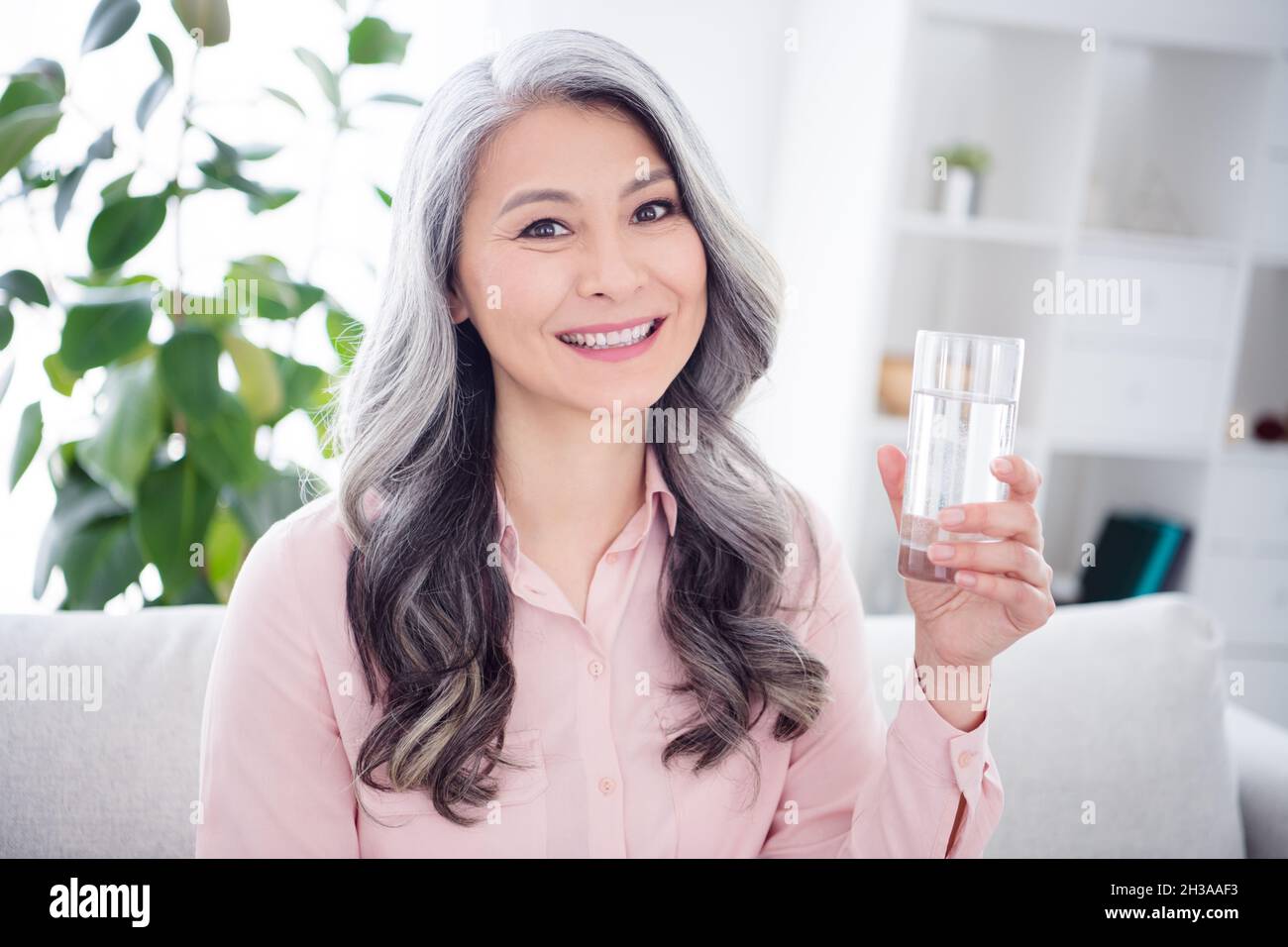 Photo of happy positive old lady smile good mood hold water glass ...