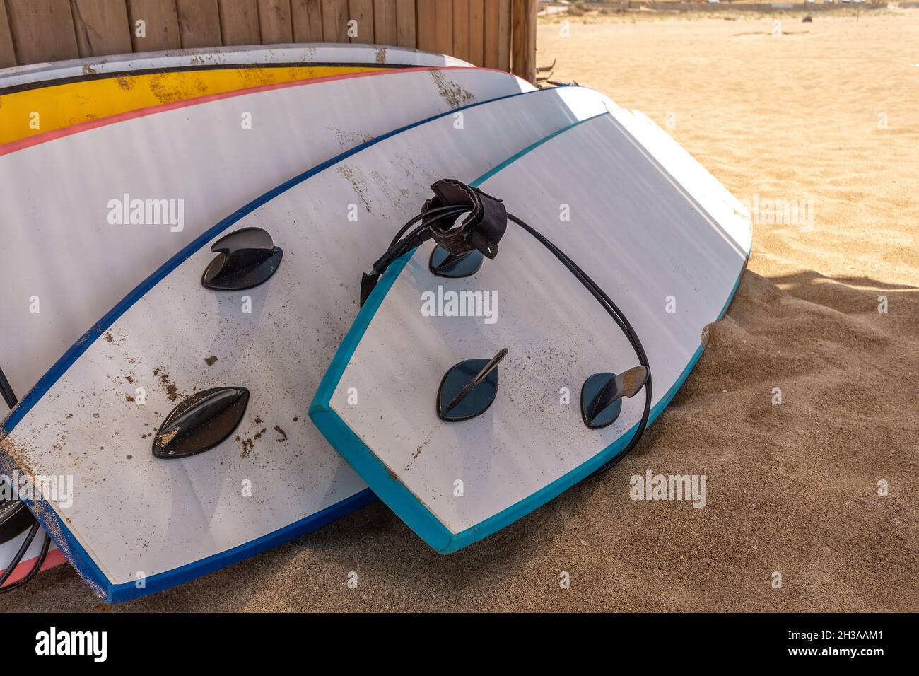 Few surfboards on sandy sea beach Stock Photo - Alamy