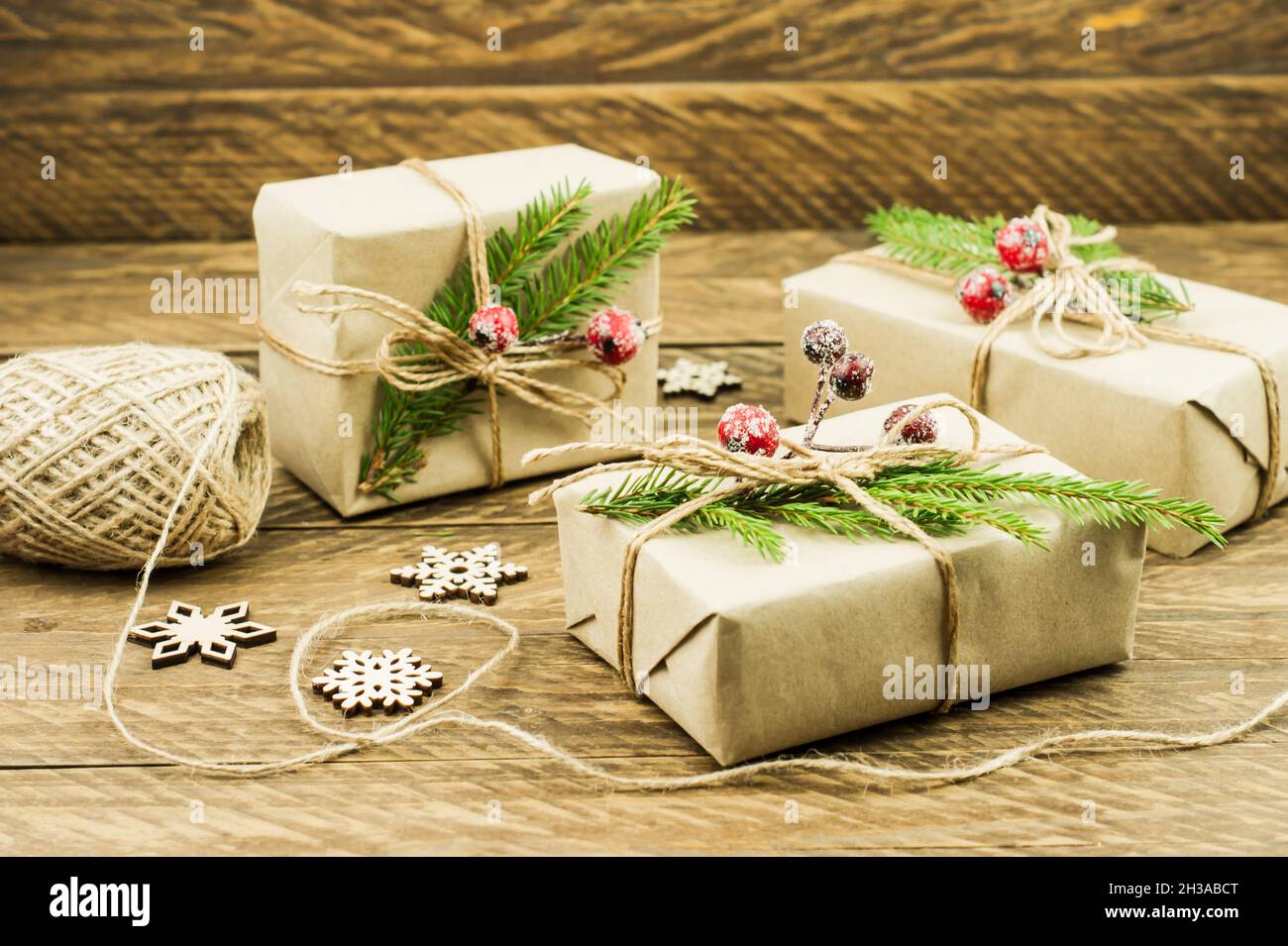Christmas presents wrapped in craft paper with natural fir tree ...
