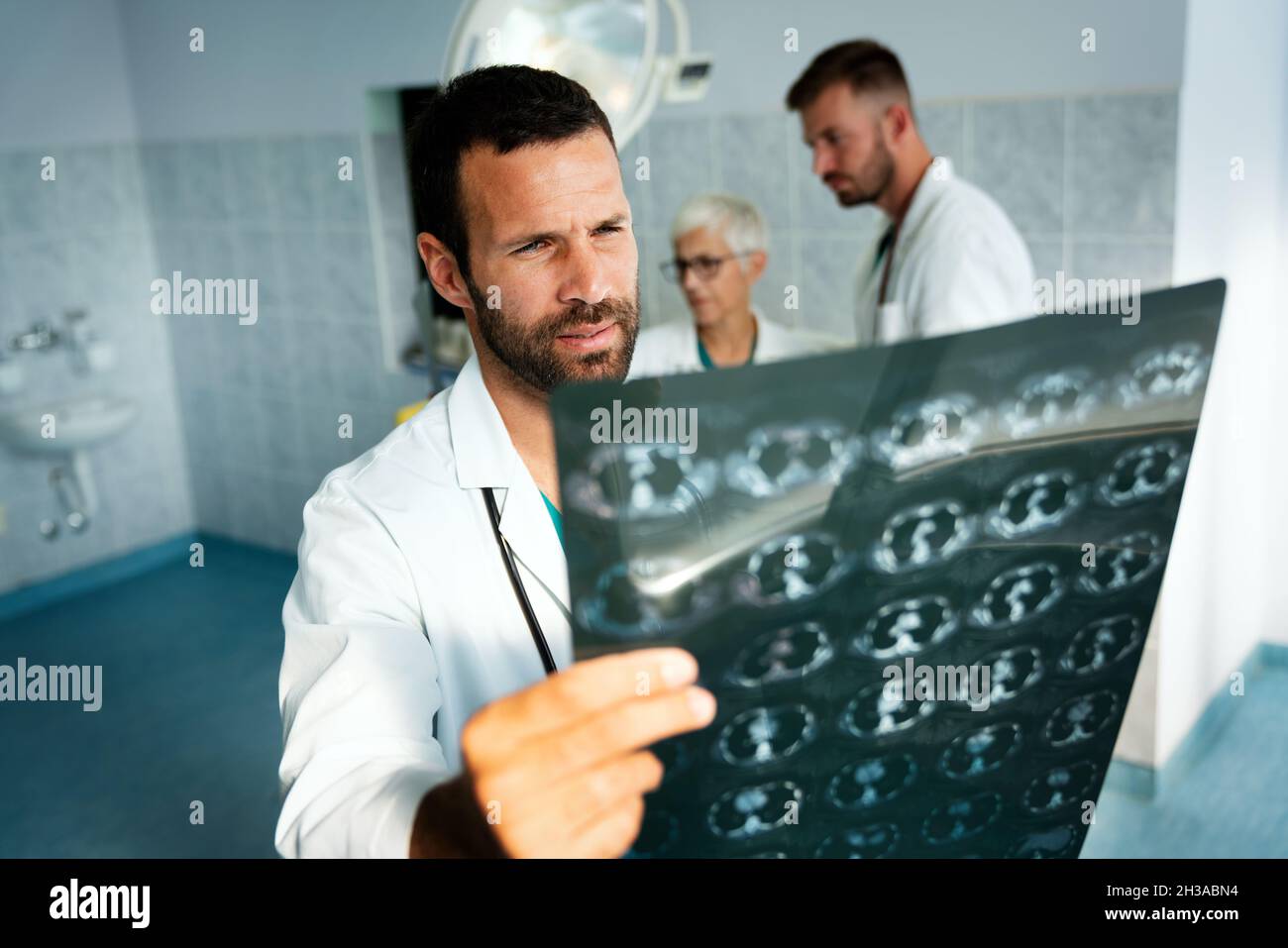 Group of doctor looking at ct scan at hospital to make diagnosis Stock ...