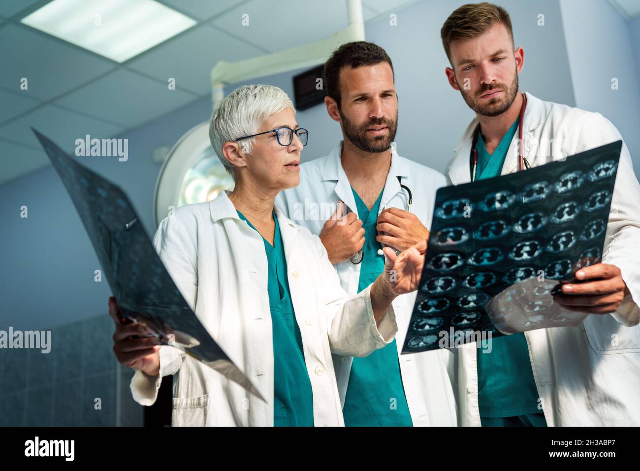 Group of radiology doctor looking at x-ray and discussing it Stock ...