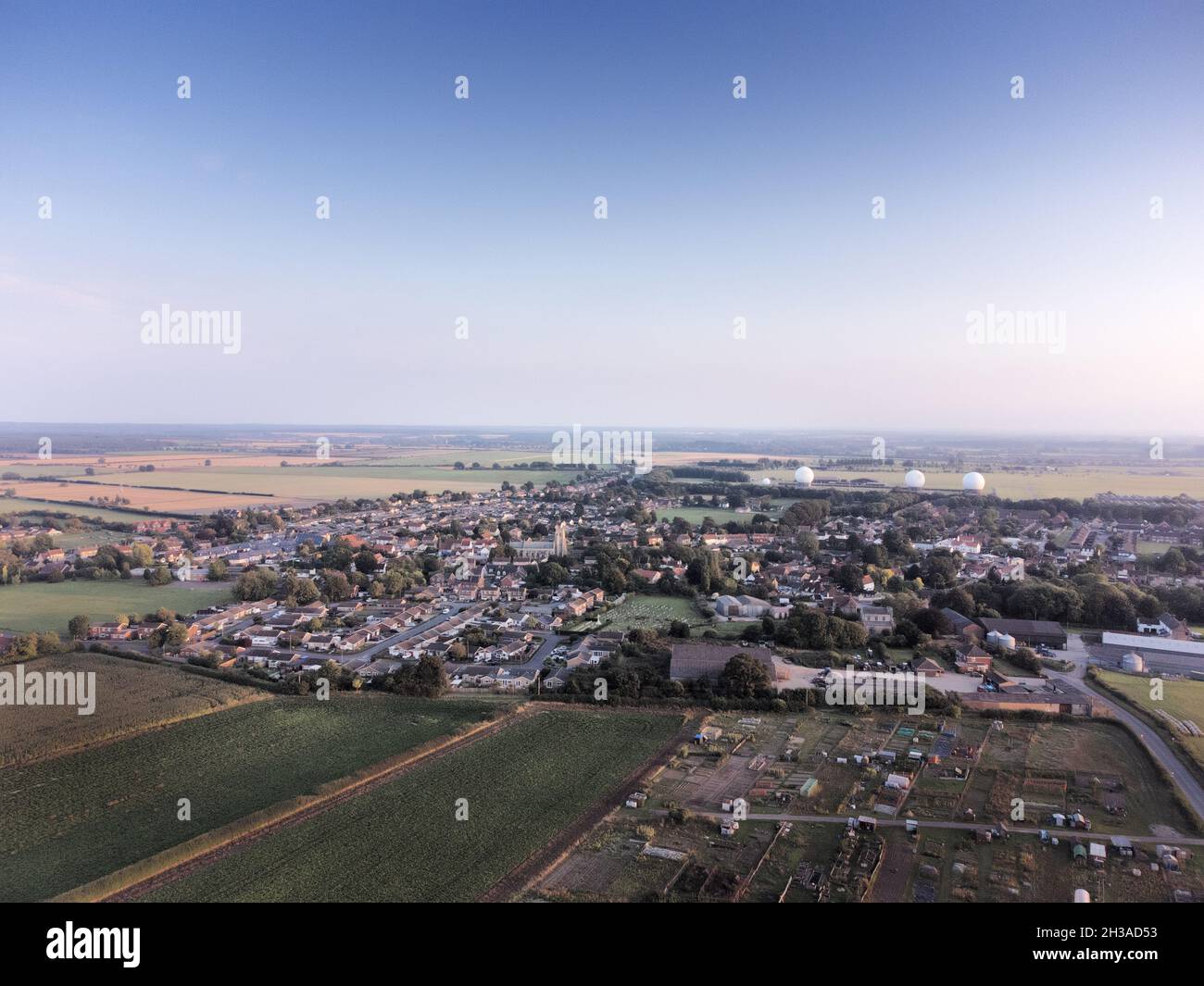 aerial image over the village of feltwell with the three white radomes ...