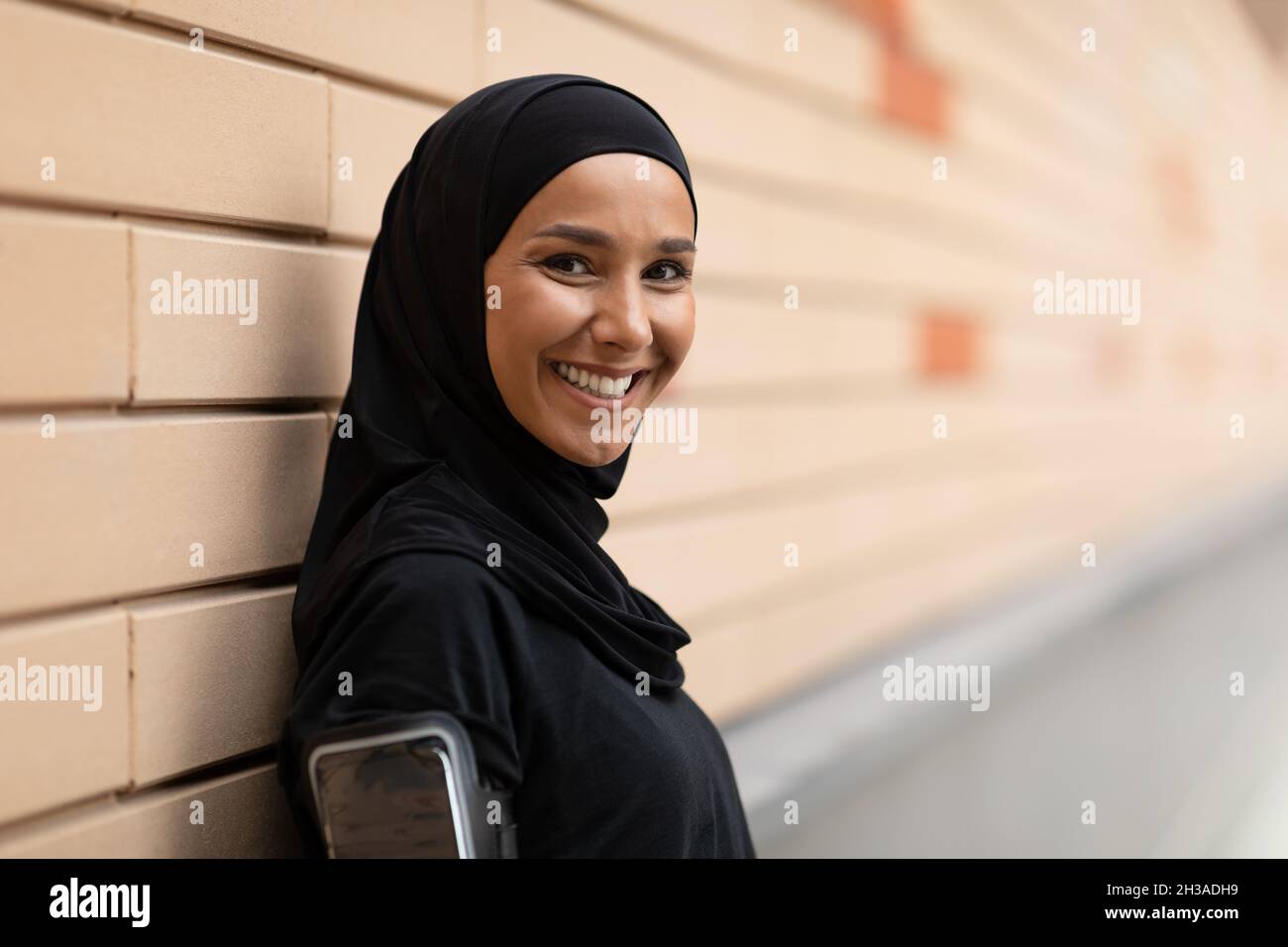 Portrait Of Smiling Young Muslim Lady In Hijab Posing During Training ...