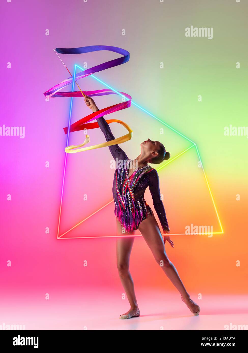 Creative artwork of prfessional female rhythmic gymnast in motion with ...