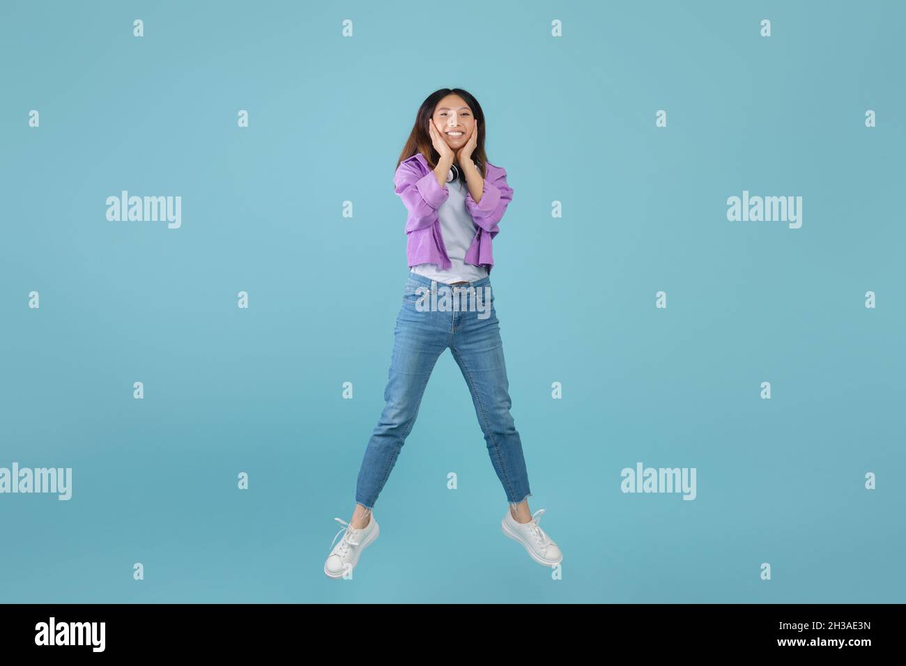 Shocking sale. Surprised amazed young asian lady jumping in air and ...