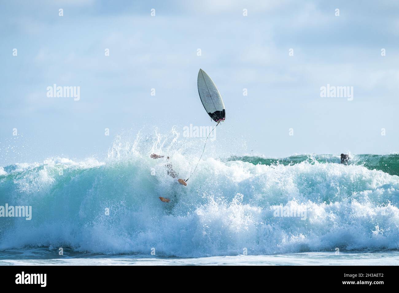 Surfer crashing in the wave in Montanita, Ecuador Stock Photo - Alamy