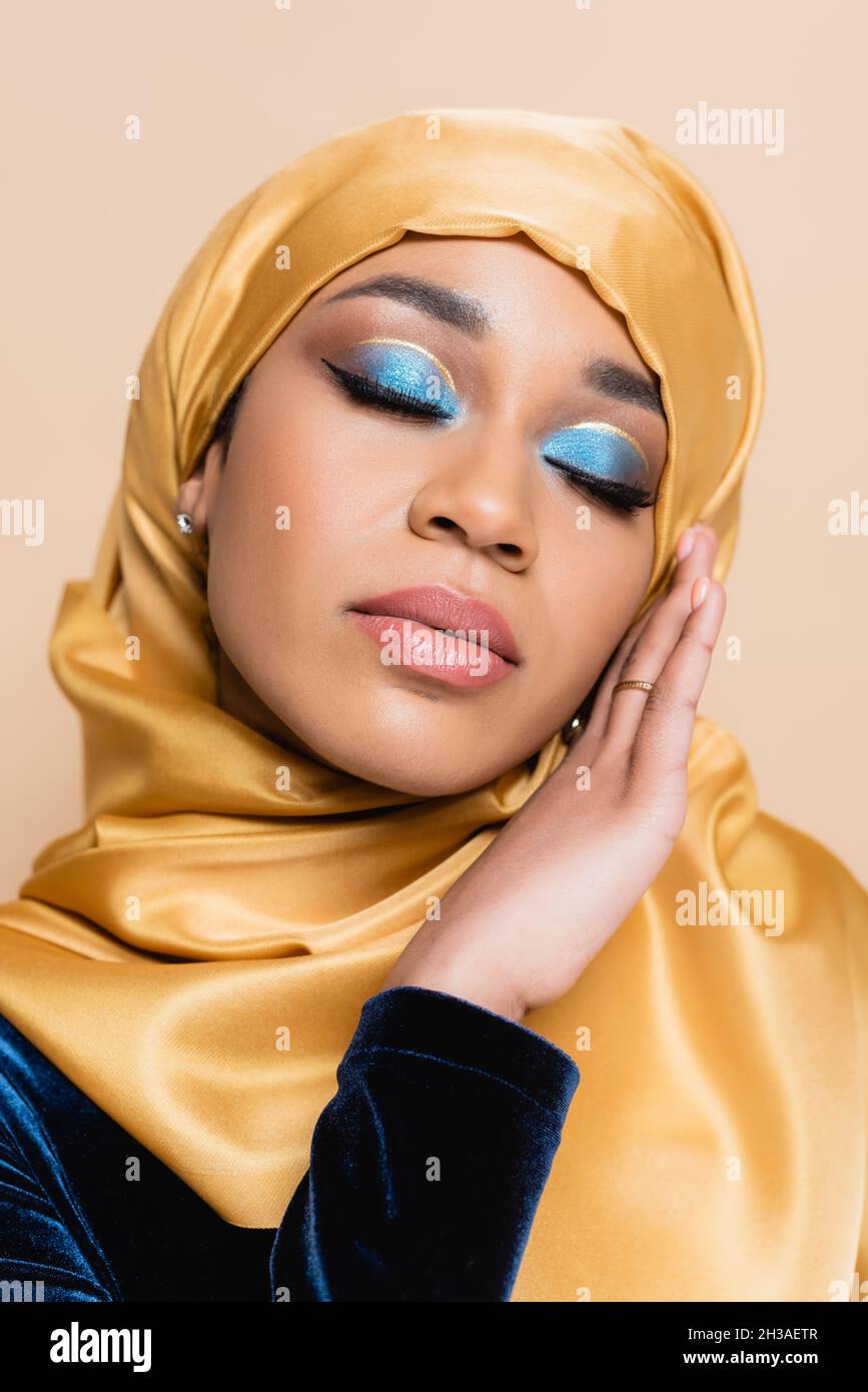 muslim woman in hijab with bright blue eye makeup and closed eyes ...