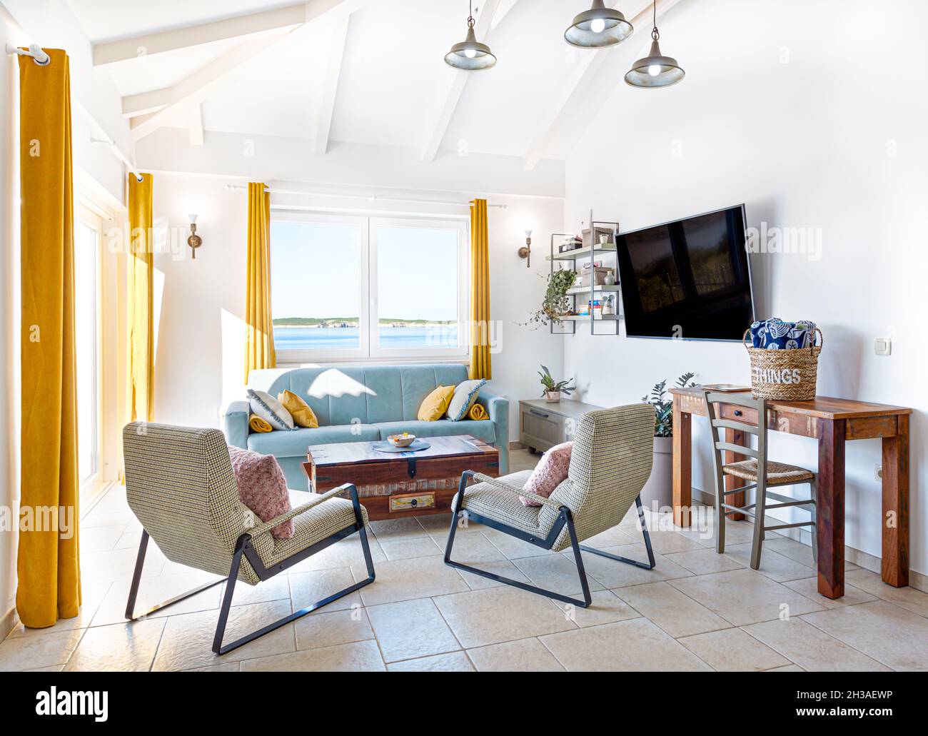 Cozy decorated living room with seaside view Stock Photo - Alamy