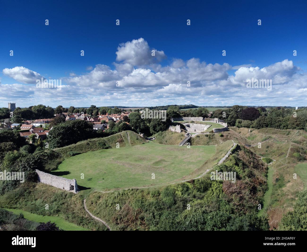 aerial landscape image of a ruined medieval building in the village of ...