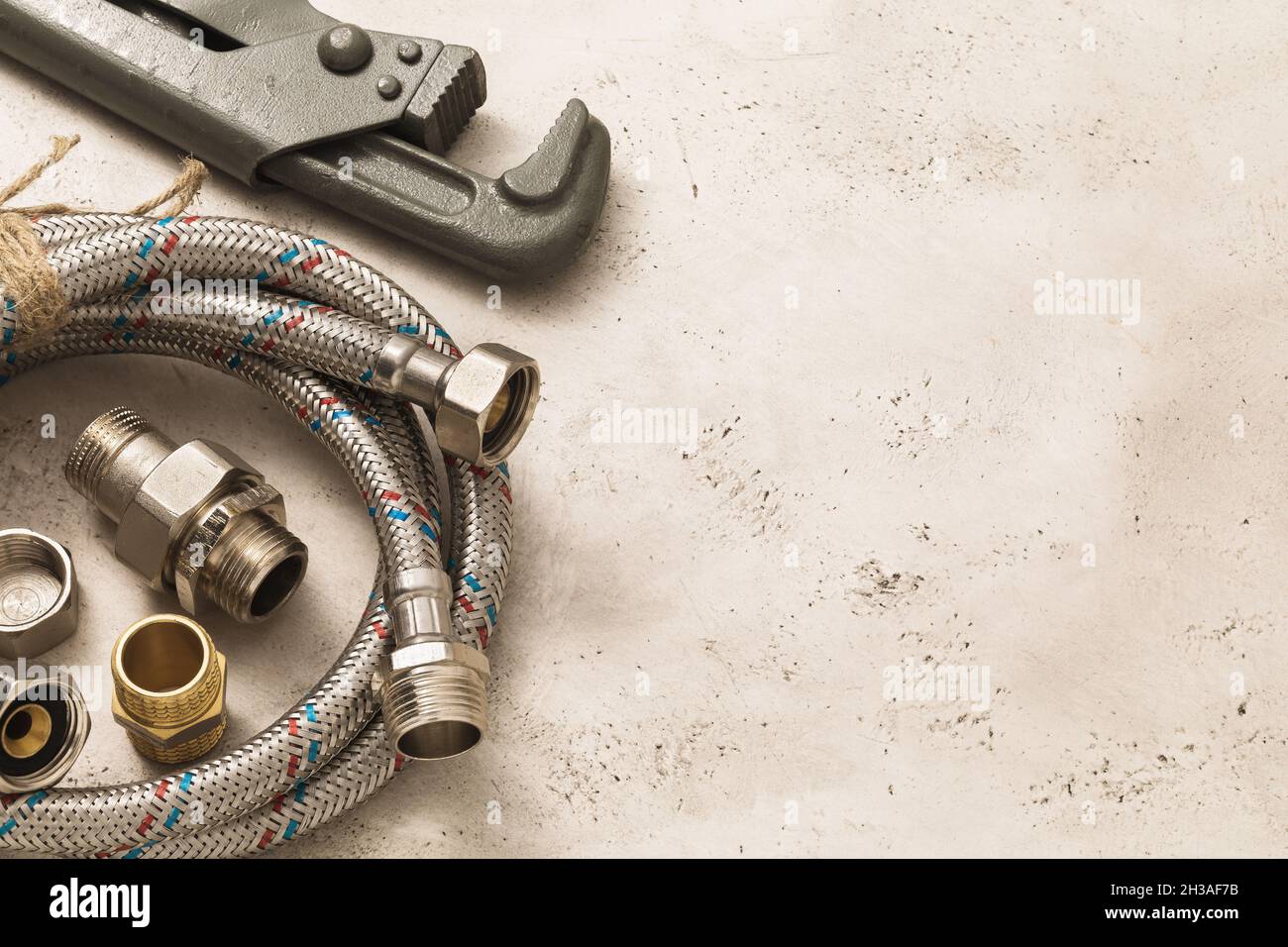 Plumbing tools with copy space on the left side of the table, wrenches ...