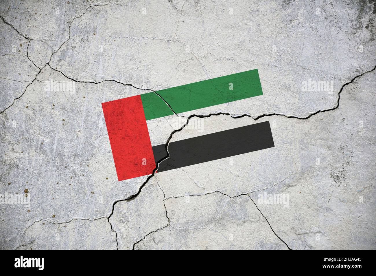 An old image of the flag of United Arab Emirates on a wall with a crack ...