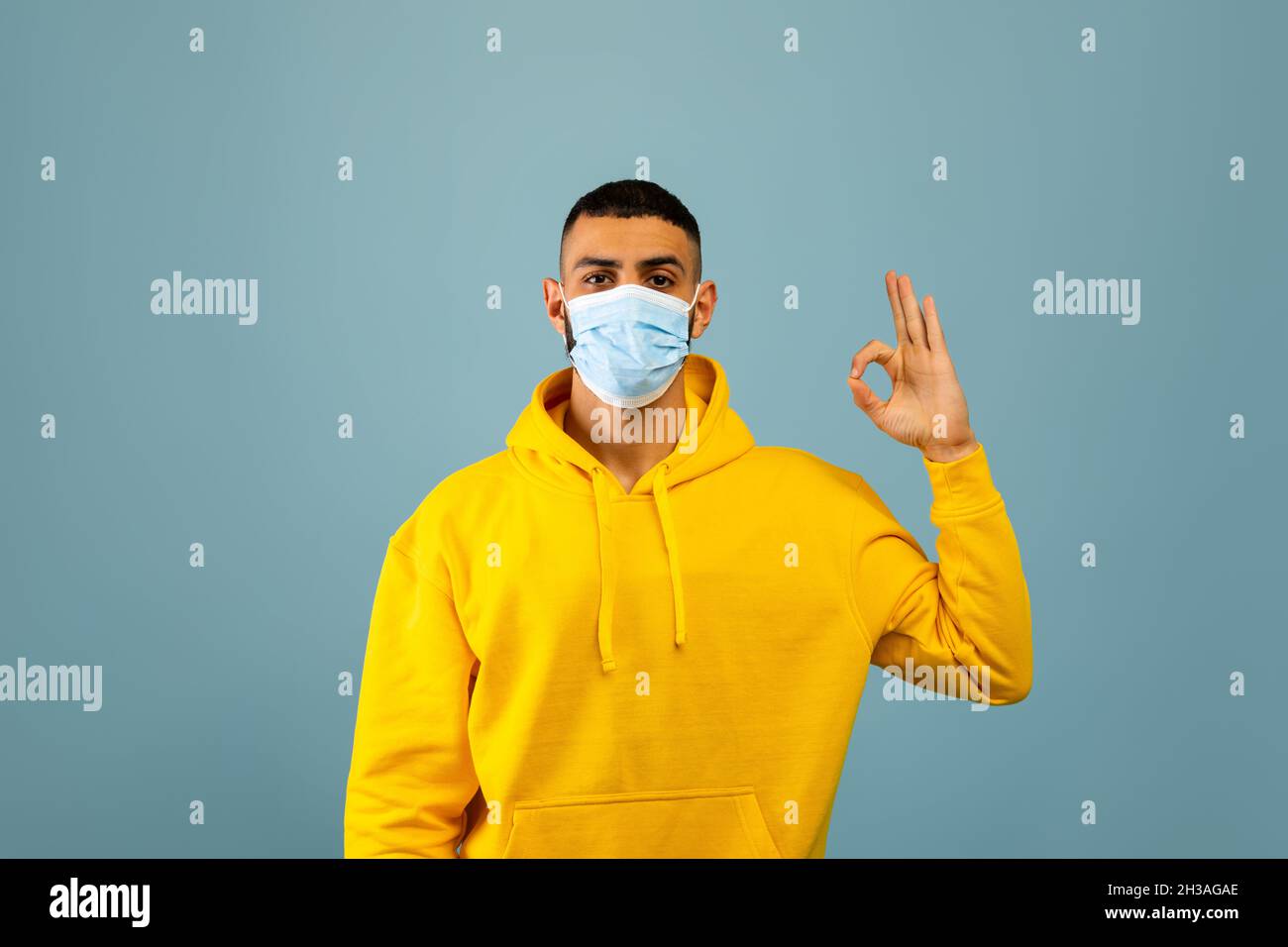 Protection against disease. Millennial arab man wearing medical ...