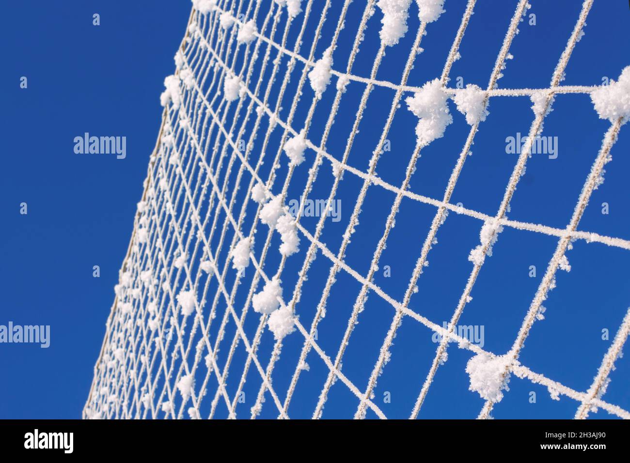 Volleyball net covered with snow. Nature's minimalism Stock Photo - Alamy