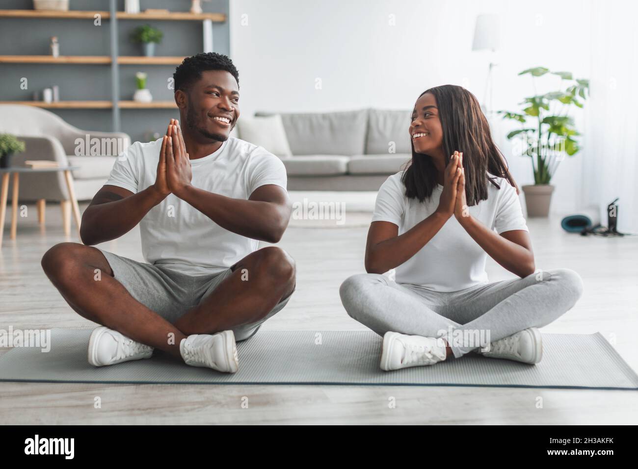 Black Couple Meditating Keeping Hands Together In Prayer Pose Stock