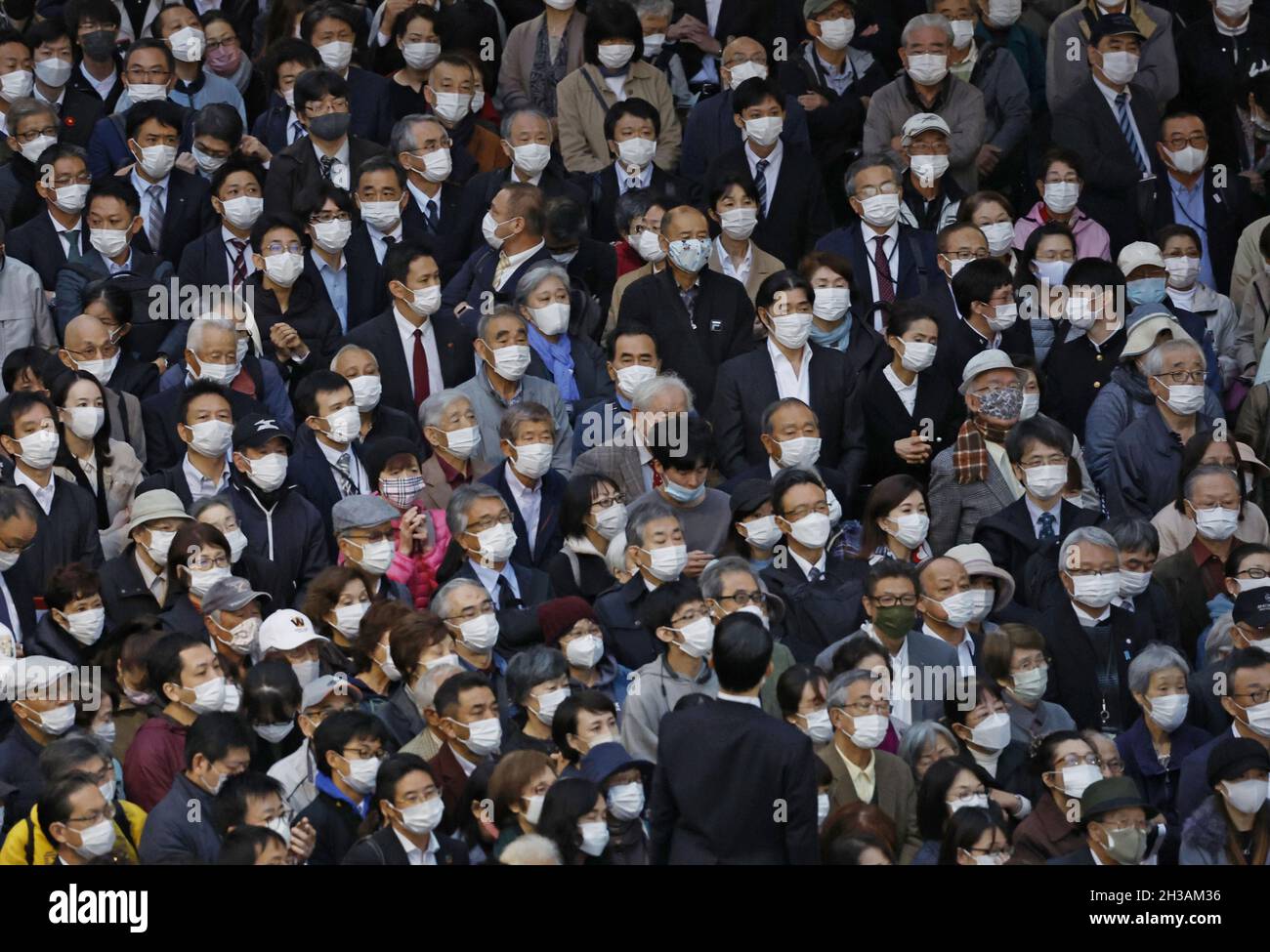 People listen to a politician making a stump speech in Tokyo on Oct. 27, 2021, ahead of a ...