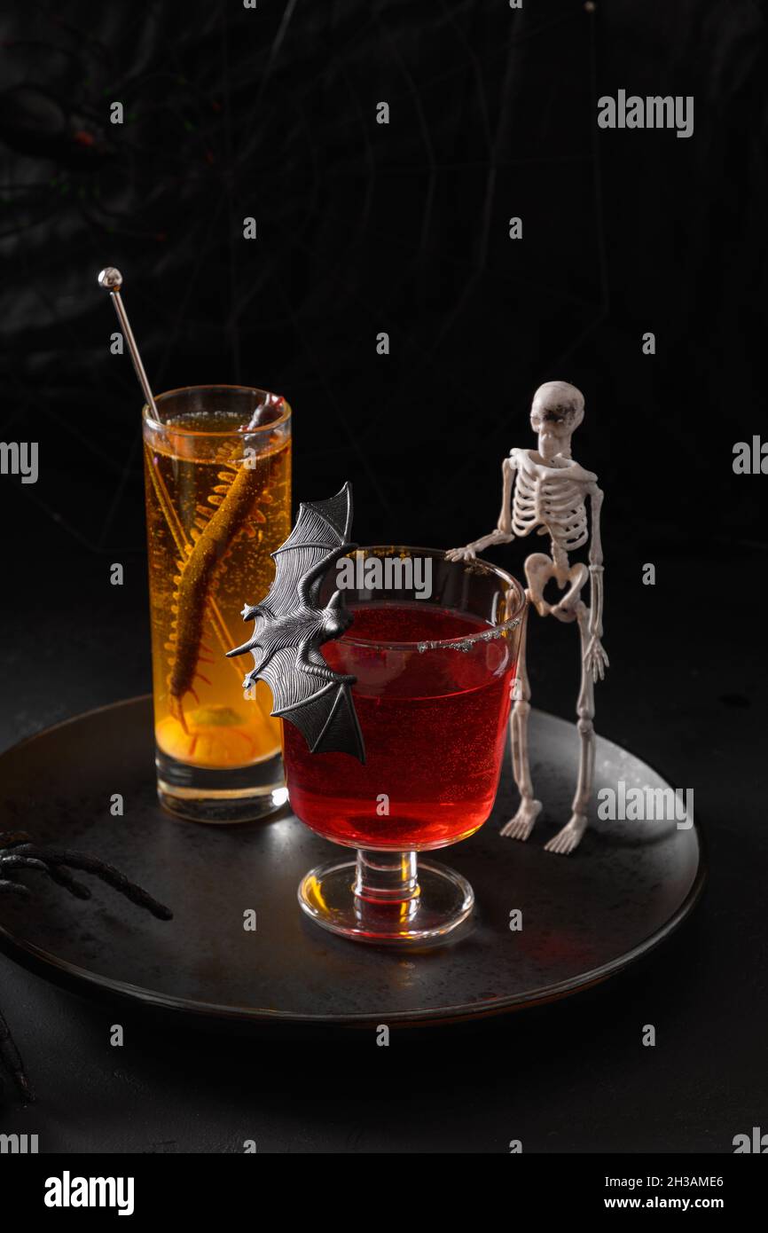 Halloween red and orange alcoholic cocktails decorated bat and skeleton ...