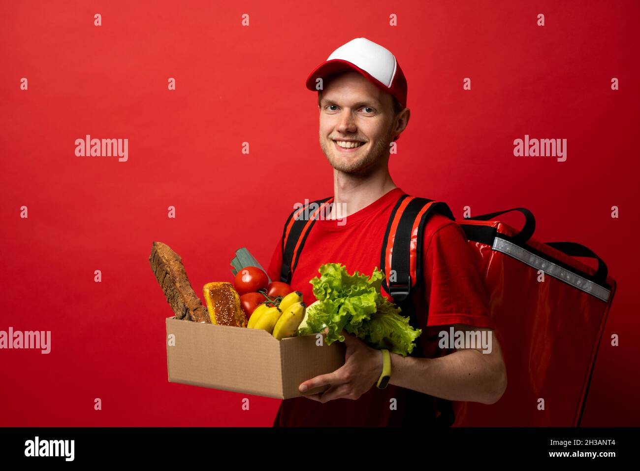 Courier carrying package box of grocery food and drink from store ...