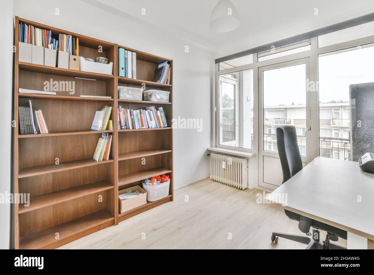 Working office with a bookcase with books Stock Photo - Alamy
