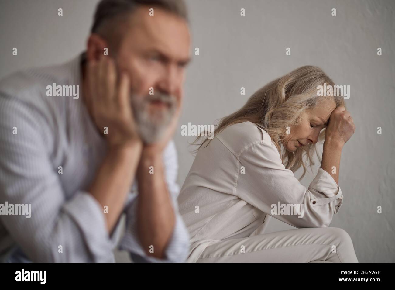 Mature couple ignoring one another after a conflict Stock Photo - Alamy