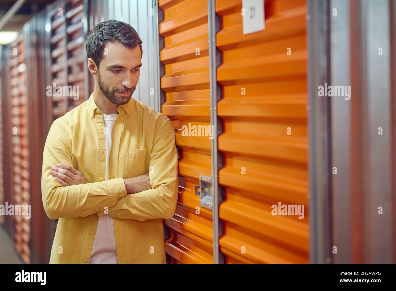 Interested man looking at garage lock Stock Photo - Alamy