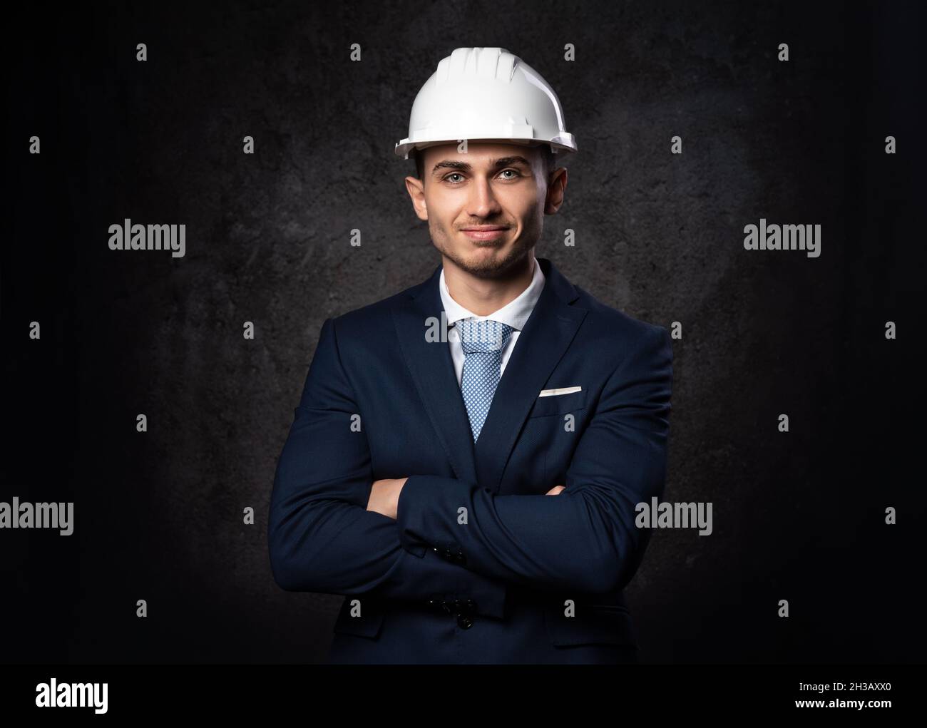 Young caucasian businessman architect engineer, with white safety ...