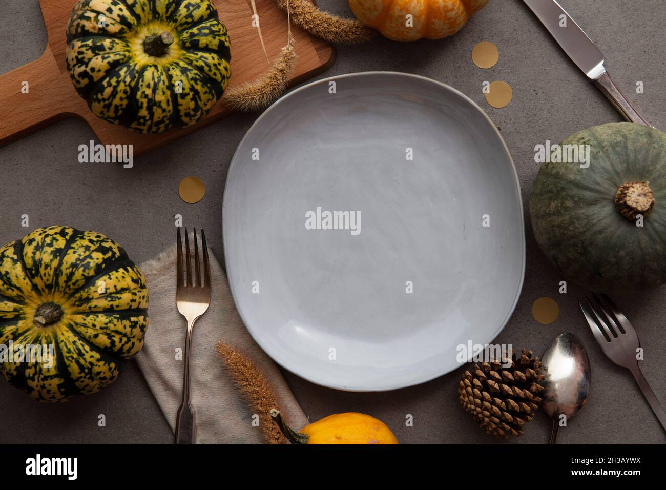 Overhead autumn thanksgiving dinner place setting with pumpkins cutlery ...