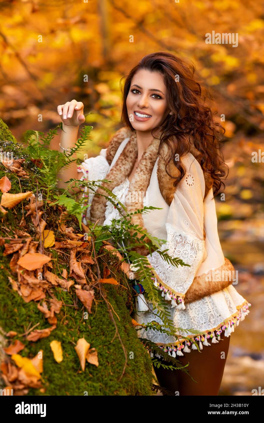 Autumn portrait with a beautiful woman in different positions near a ...
