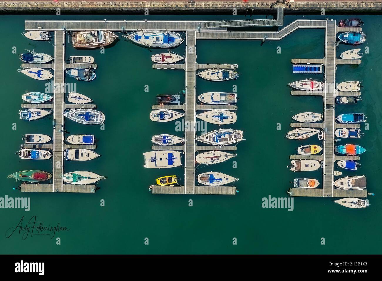 Beautiful aerial view of aligned columns of colorful boats in the water ...