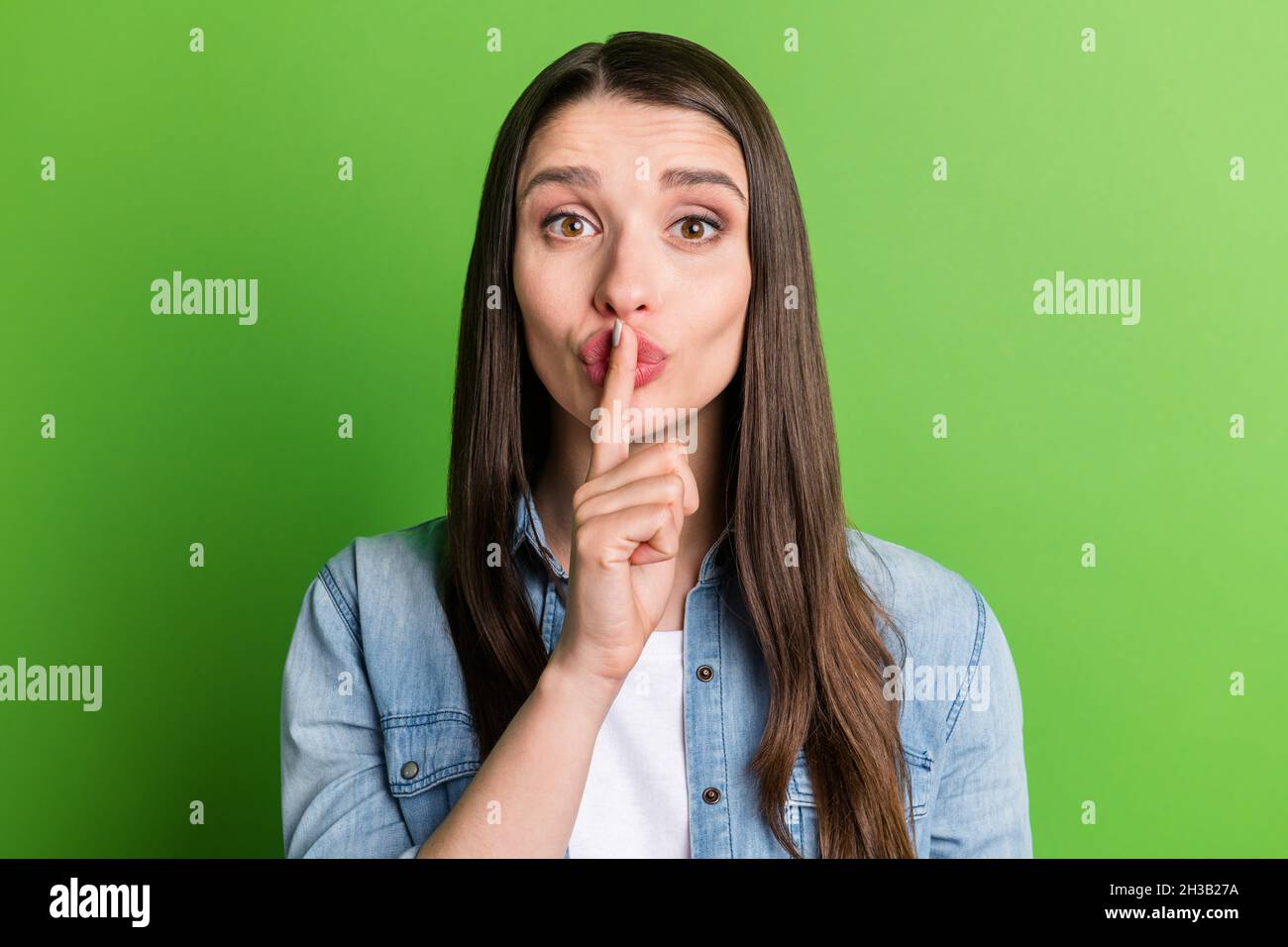 Portrait of attractive mysterious girl showing shh sign isolated over ...