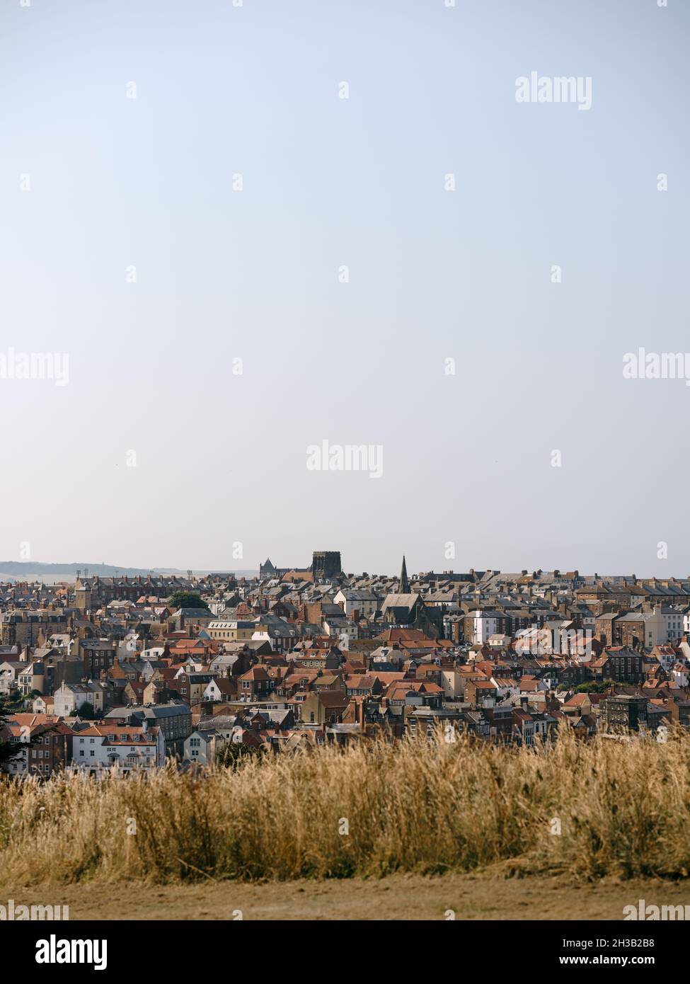 The summer rooftops townscape of Whitby in North Yorkshire looking sown ...