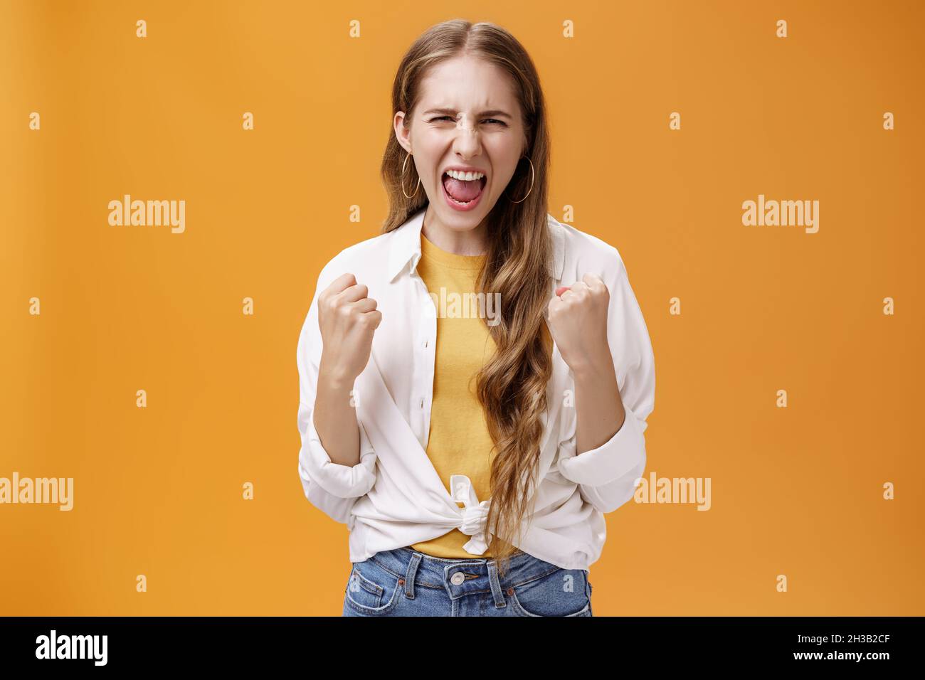 Girl feeling power overcome any trouble yelling to cheer up and boost ...