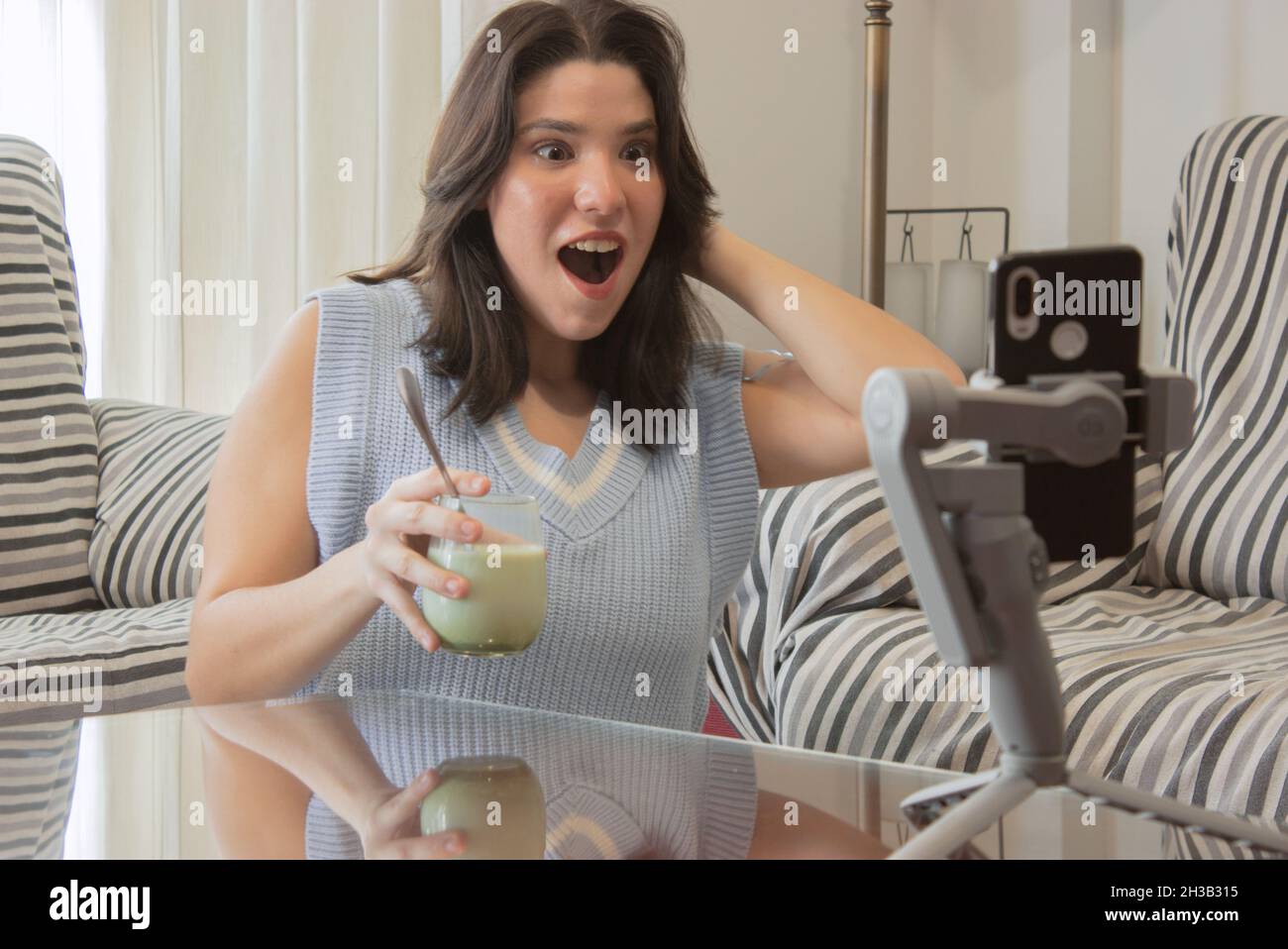 Young girl with a surprised face after receiving surprise news from her ...