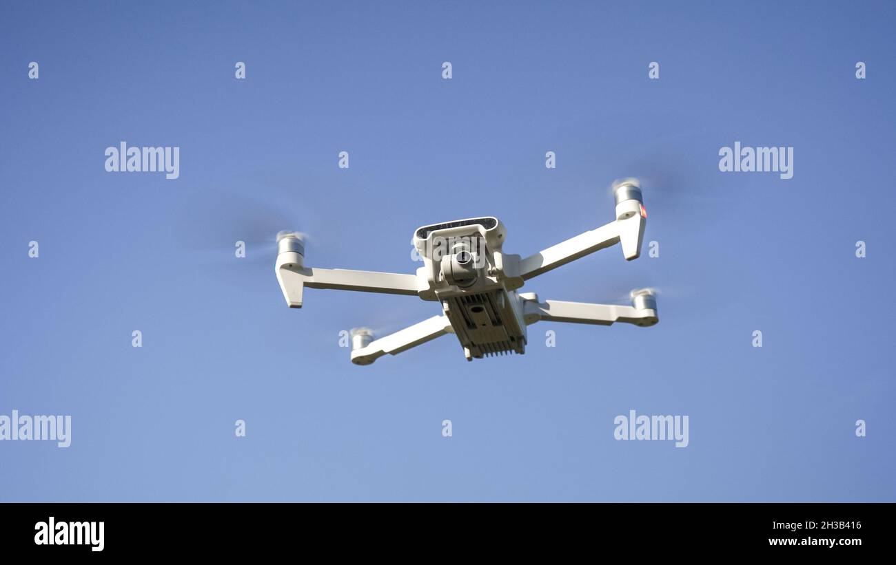 White Drone Flying on Nature Background. Drone Hanging in Air Flying ...