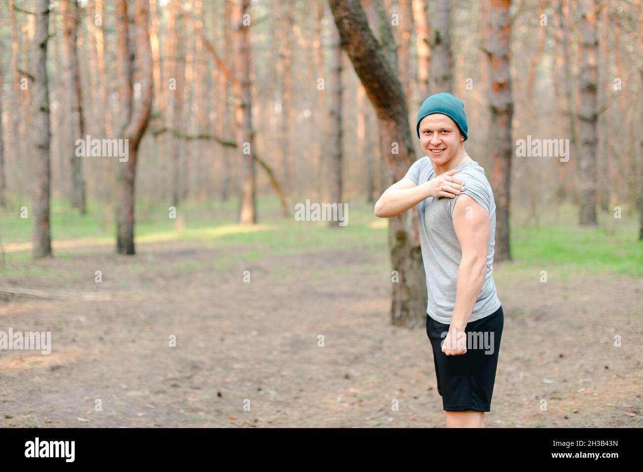 Young boy doing workout in morning park and showing biceps Stock Photo ...
