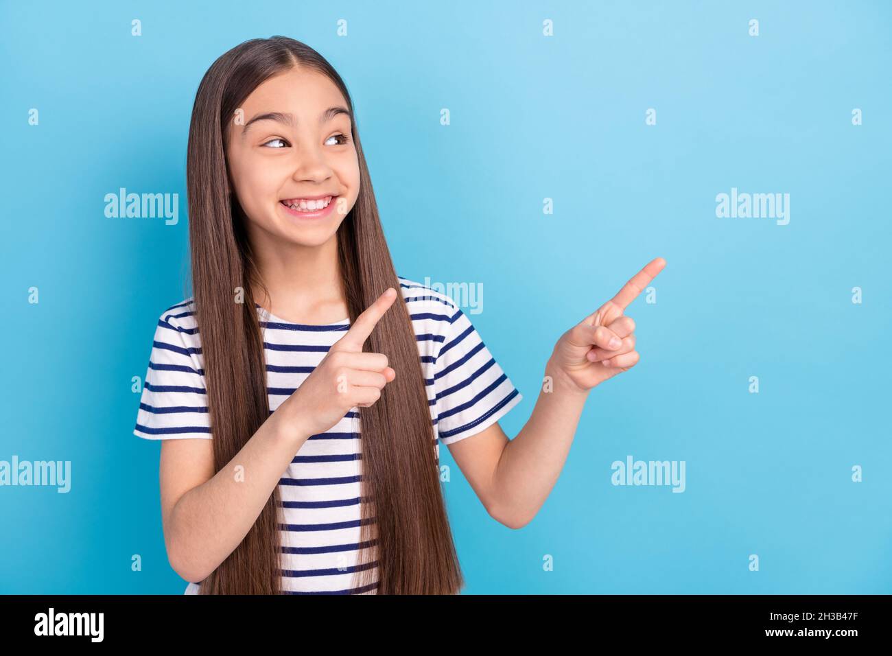 Photo of young girl happy positive smile point fingers empty space ads ...