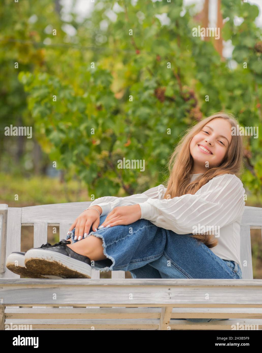 glad child sit on bench outdoor, relaxation Stock Photo - Alamy