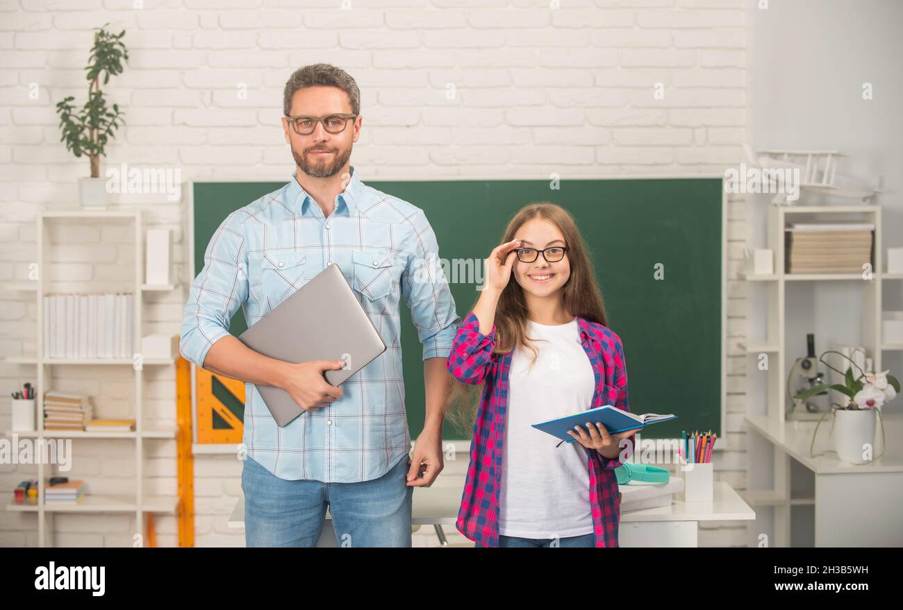 private teacher and child hold copybook. family help. dad and daughter ...
