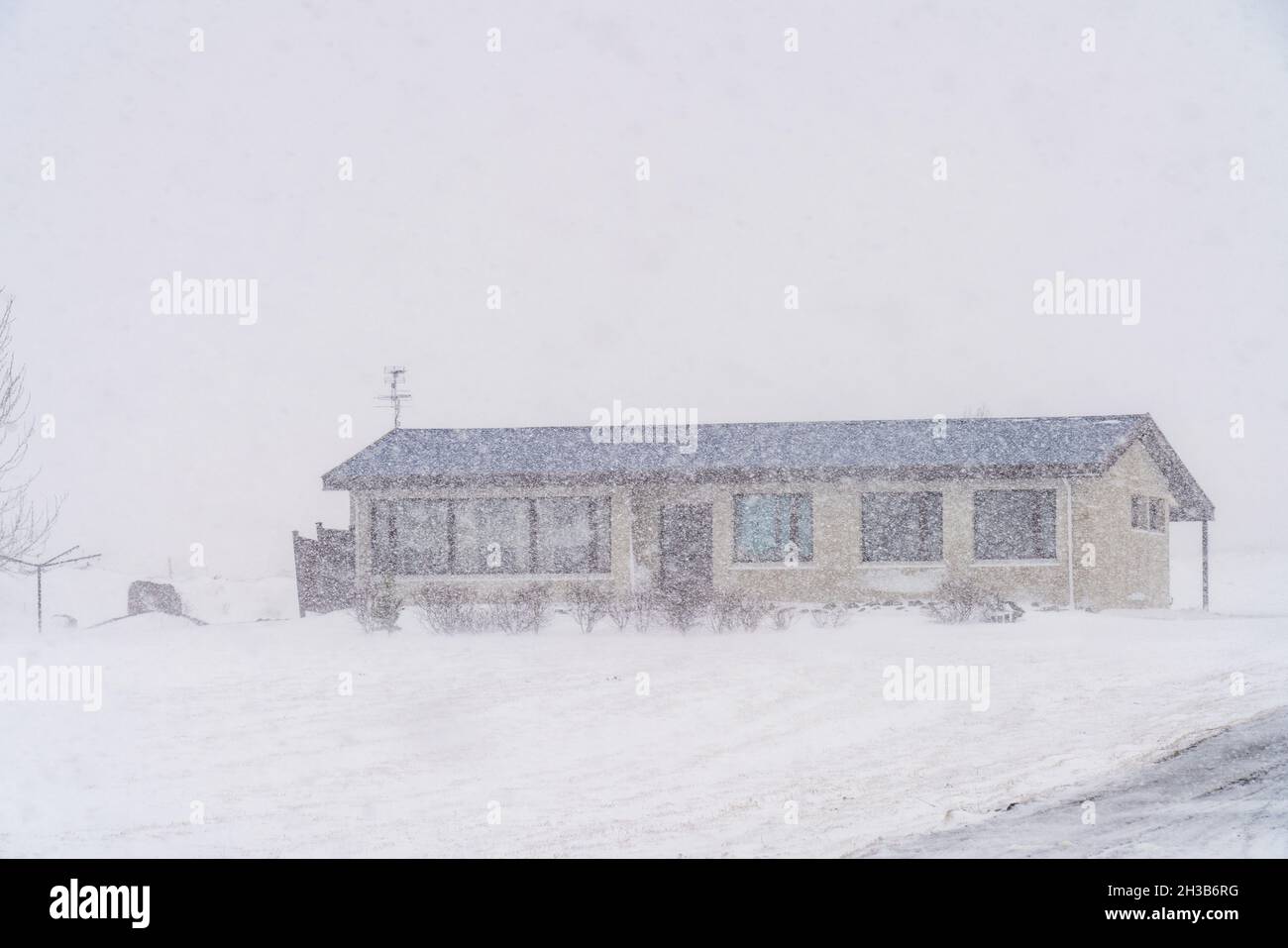 A snowstorm and a house in the snow. Winter in Iceland Stock Photo - Alamy