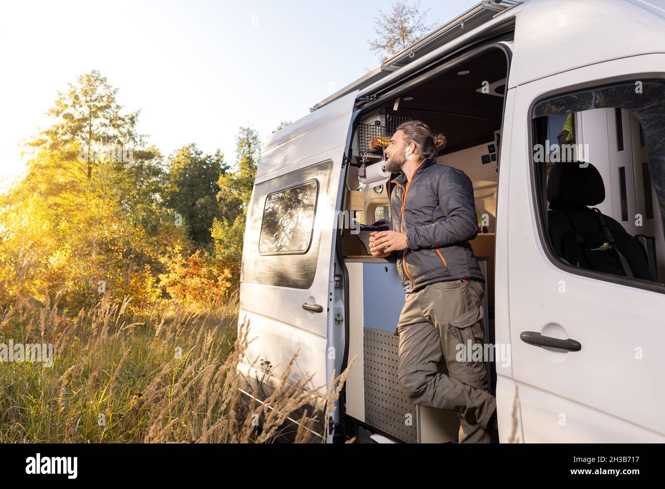 Man and his his camper van standing in an autumn scenery Stock Photo ...