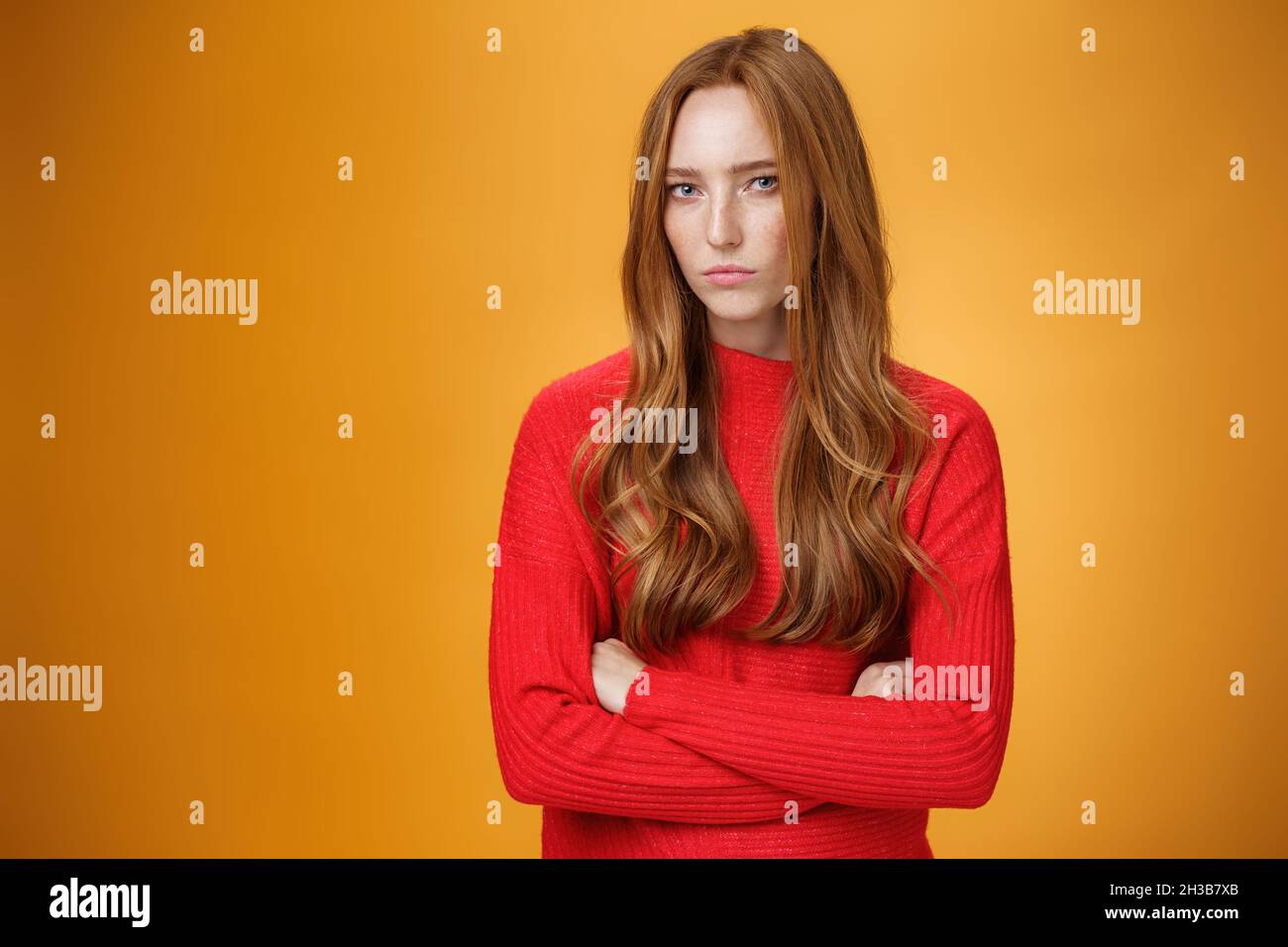 Suspicious intense and defensive ginger girl standing in passive ...