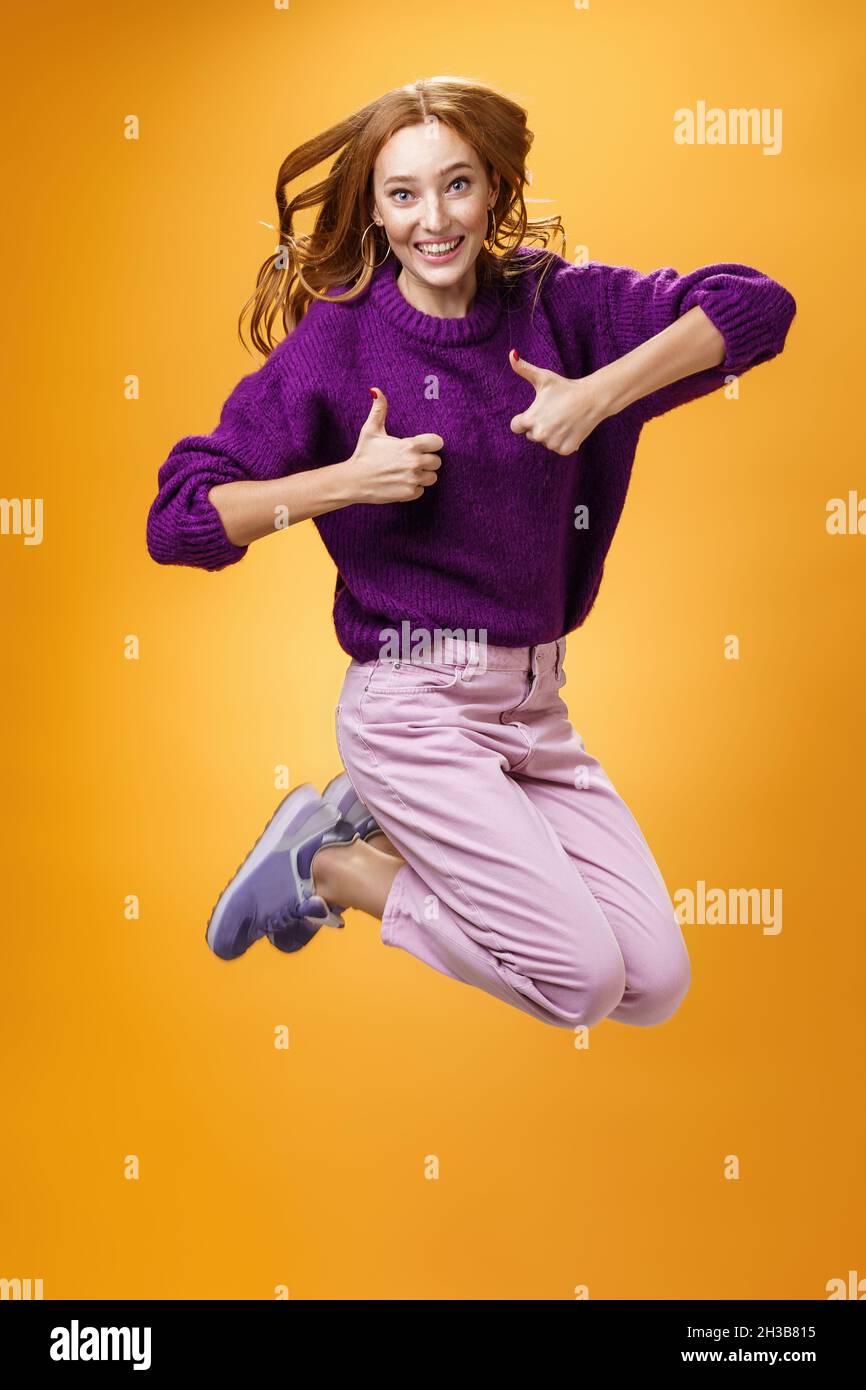 Optimistic and cheerful woman liking promotion lifting thumbs up and ...