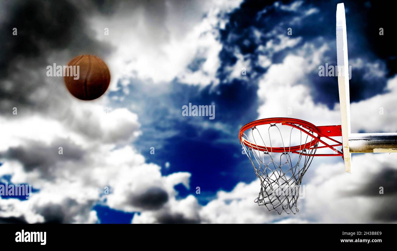 Outdoor basketball with clouds and sky and shot to the hoop ball ...