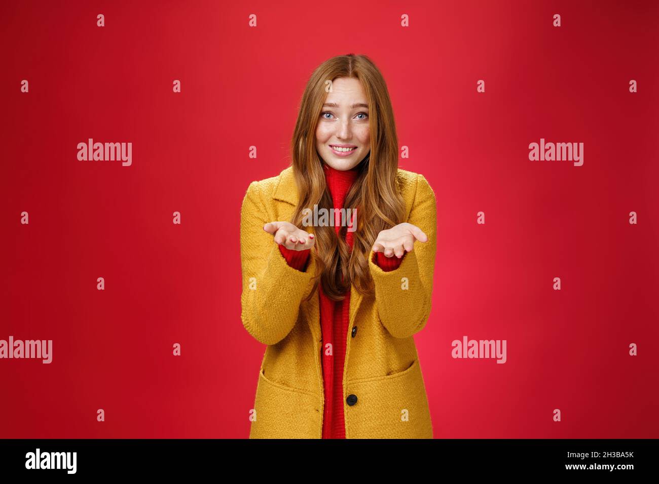 Girl with tender and caring expression smiling extanding hands forward ...