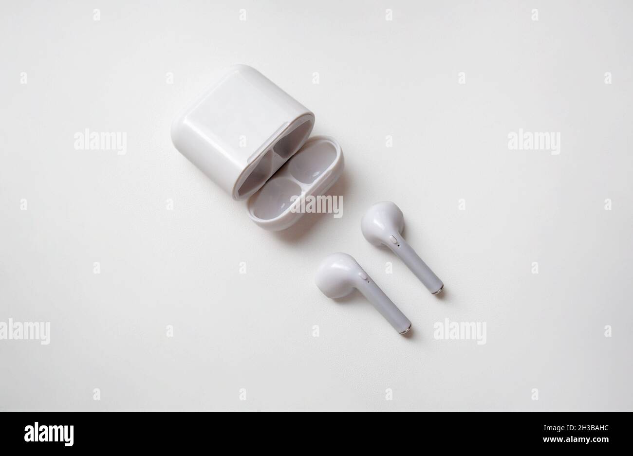 Plastic wireless earbuds with container mockup isolated on white ...