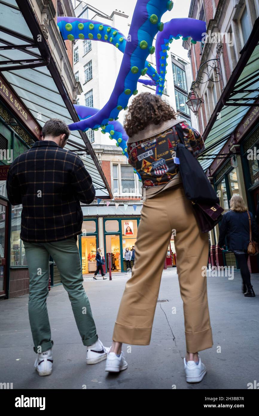 London, UK. 27 October 2021. A couple takes photos of a set of ...