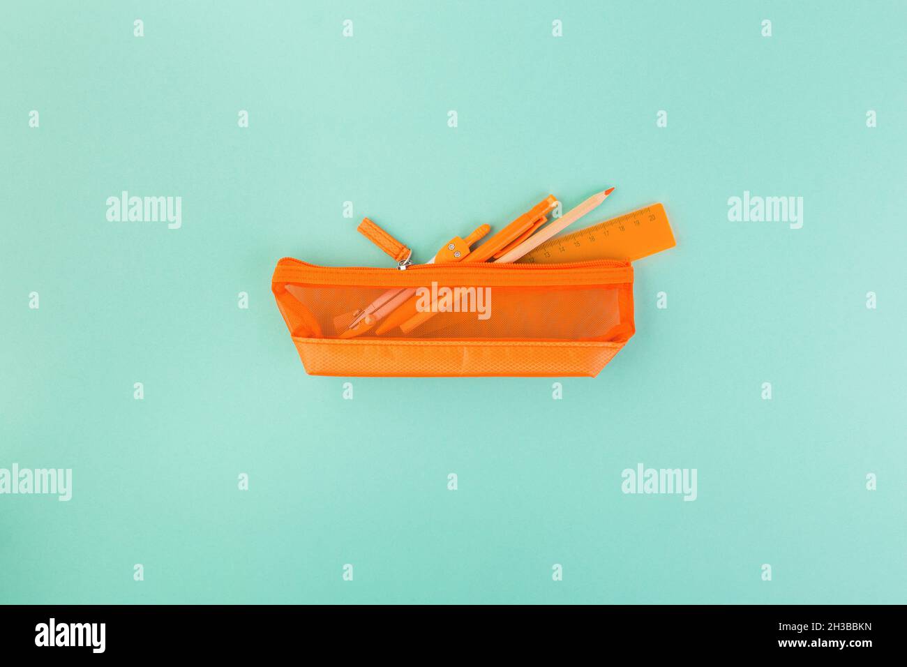 Different orange school supplies in case. Back to school concept. Flat ...