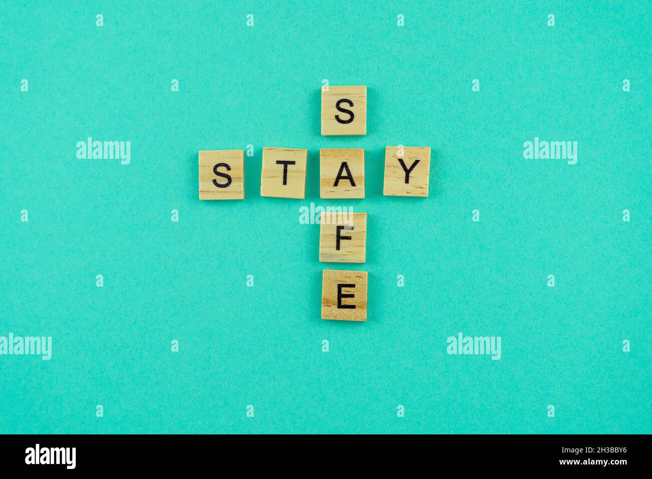 Word stay safe. The phrase is laid out in wooden letters. Top view ...