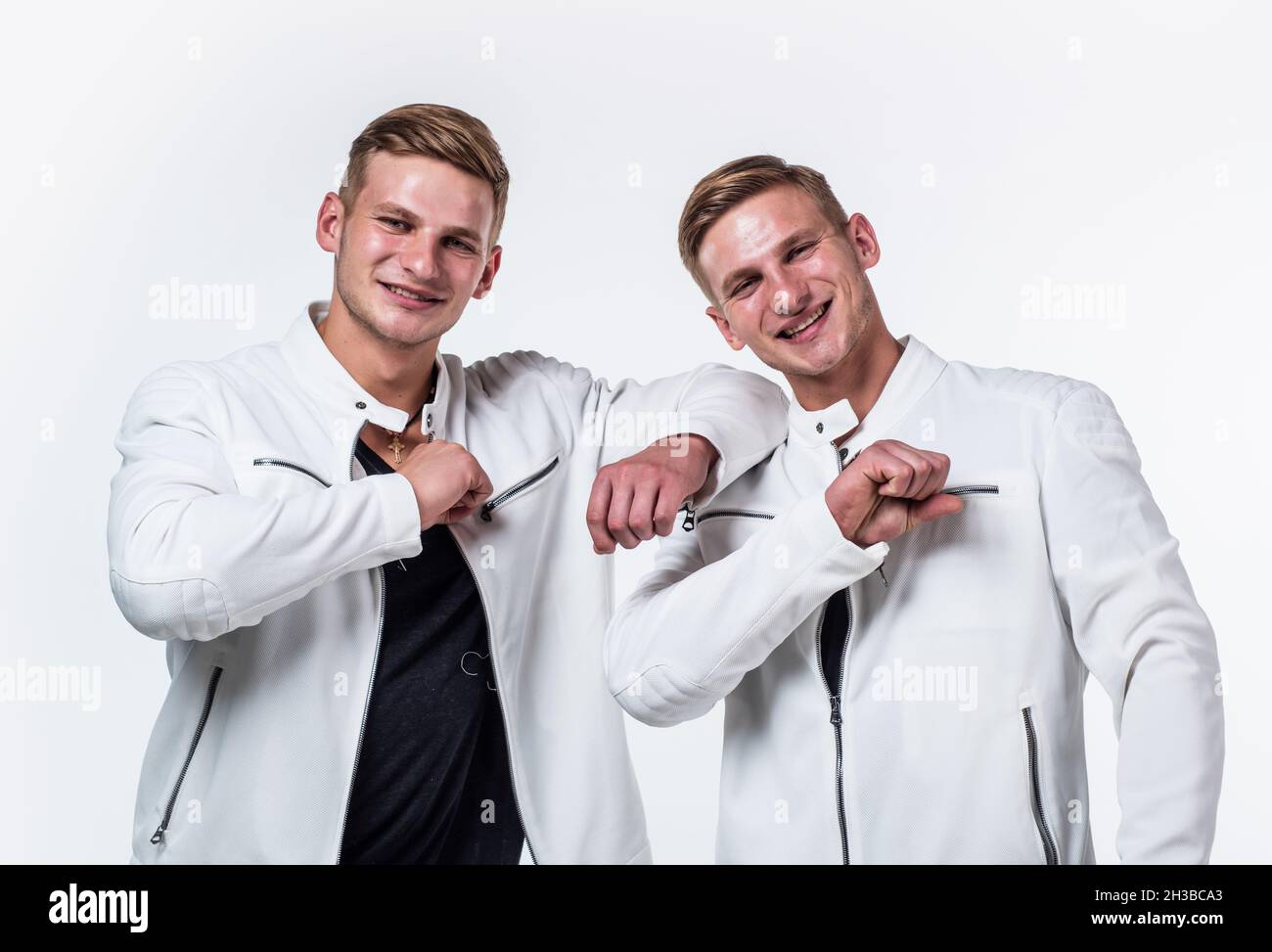 twin brothers men in white casual clothes look alike, together Stock ...