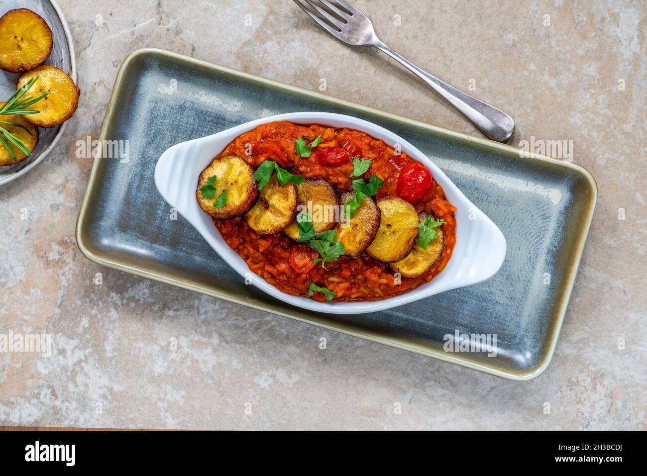 Jollof rice with deep fried plantain - spicy vegetarian African rice ...