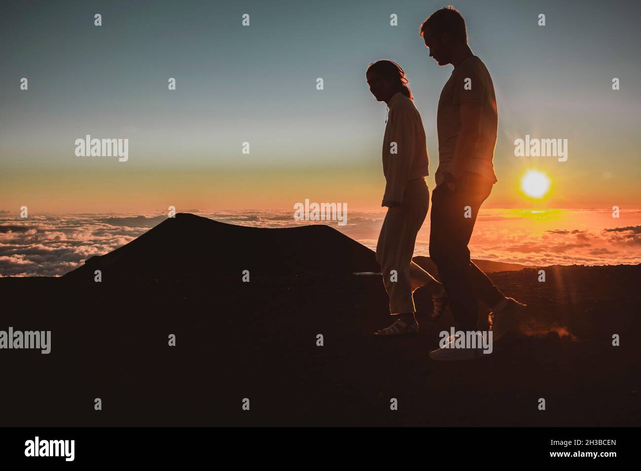 Friends walk at sunset on top of Mauna Kea Stock Photo - Alamy